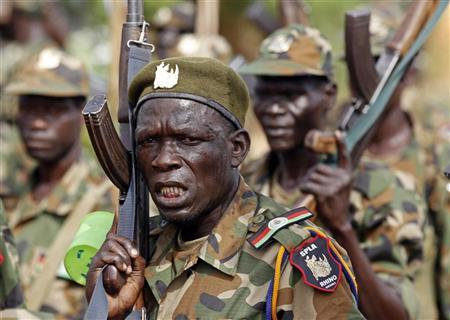 Soldiers of South Sudan’s SPLA army shout at a military base in Bentiu ...