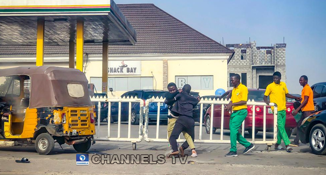 PHOTOS: Tricyclist, Motorist Exchange Blows Amid Fuel Scarcity In Abuja • Channels Television