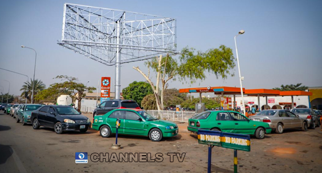 PHOTOS: Tricyclist, Motorist Exchange Blows Amid Fuel Scarcity In Abuja – Channels Television